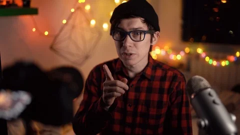 Happy young man vlogger in black hat spe... | Stock Video | Pond5