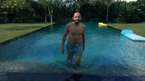 Happy, young man walking out of swimming... | Stock Video | Pond5