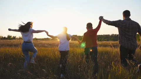 Happy young parents with kids run throug... | Stock Video | Pond5