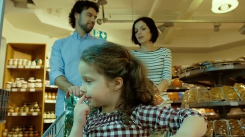 Happy young parents pushing a shopping t... | Stock Video | Pond5