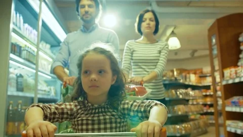 Happy young parents pushing a shopping t... | Stock Video | Pond5