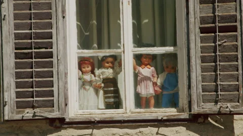 Haunted, spooky dolls in a window ( cree... | Stock Video | Pond5