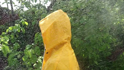 Head in yellow hood on the rain | Stock Video | Pond5