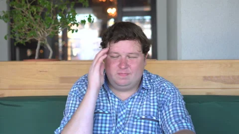 Headache or migraine. A young fat man ho... | Stock Video | Pond5