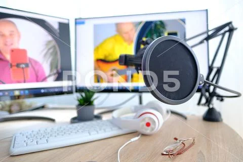 Photograph: Headphones, microphone front of computer, on screen ...