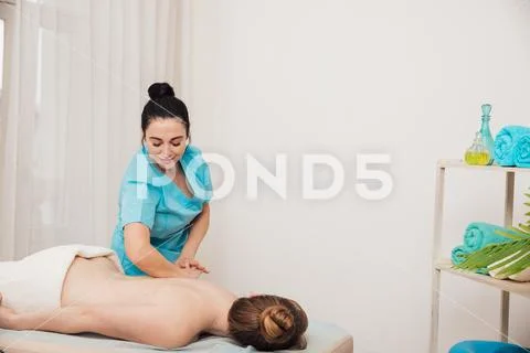 Healthy back woman massages client in massage room spa training ~ Hi Res #253285733