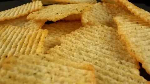 A heap of crispy ribbed chips in the dar... | Stock Video | Pond5