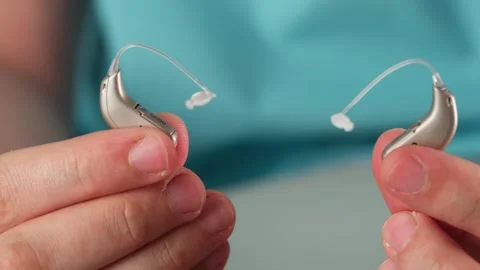 Hearing aids in hands making heart shape... | Stock Video | Pond5