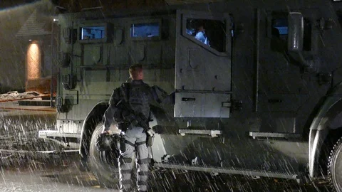 Heavily equipped tactical cop standing n... | Stock Video | Pond5