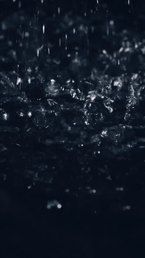 Heavy rain drops falling into puddle on ... | Stock Video | Pond5