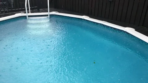 Heavy Rain Falling in backyard pool. Par... | Stock Video | Pond5