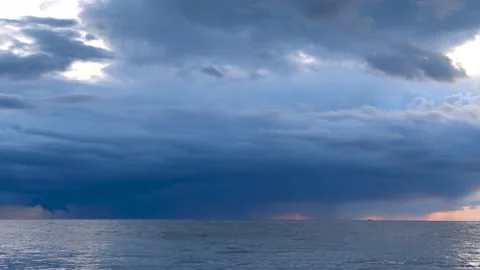 Heavy rainfall over ocean during sunset | Stock Video | Pond5