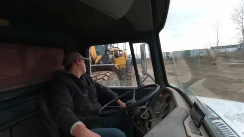 Heavy tractor loading vintage dump truck... | Stock Video | Pond5