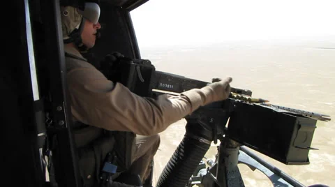 Helicopter door gunner unjams machine gu... | Stock Video | Pond5