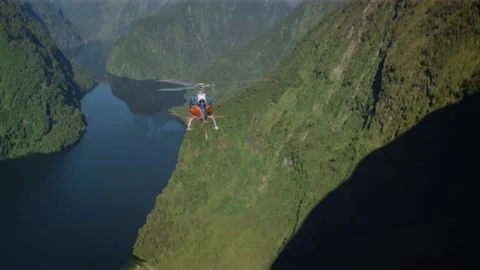 A helicopter flying over a river and lus... | Stock Video | Pond5