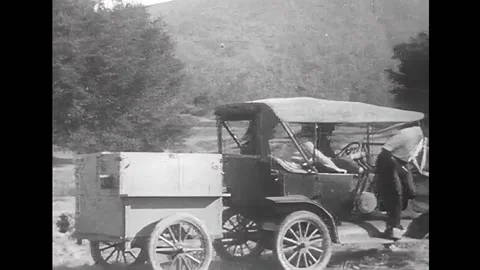 Henry Ford - people in cars with trailer... | Stock Video | Pond5