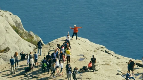Hero pose atop of Pulpit Rock, zoom pull... | Stock Video | Pond5