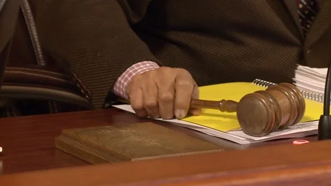 Hesitant gavel hit on table | Stock Video | Pond5