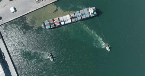 High aerial view.Tugs tow a container sh... | Stock Video | Pond5