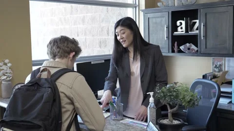 High school secretary talking with stude... | Stock Video | Pond5