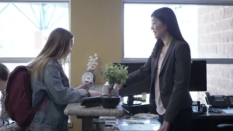 High school secretary talking with stude... | Stock Video | Pond5