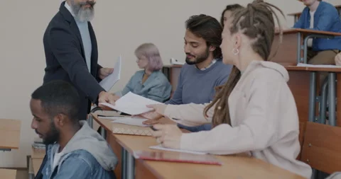 High school teacher giving papers to stu... | Stock Video | Pond5
