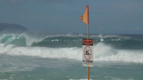 High surf ocean wave warning sign flag a... | Stock Video | Pond5