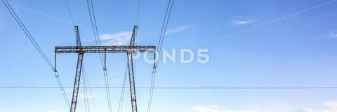 Photograph: High voltage pillar. Power grid pole against the sky. High ...