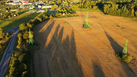 High voltage power lines in field and hi... | Stock Video | Pond5