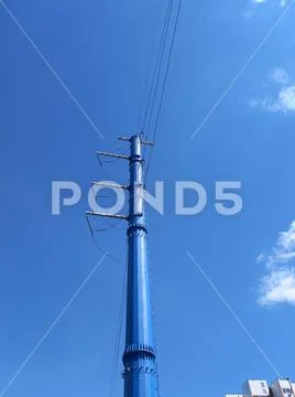 High-voltage power lines of a new sample of blue color against a blue ...