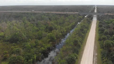 highway bridge over canal dirt road over... | Stock Video | Pond5