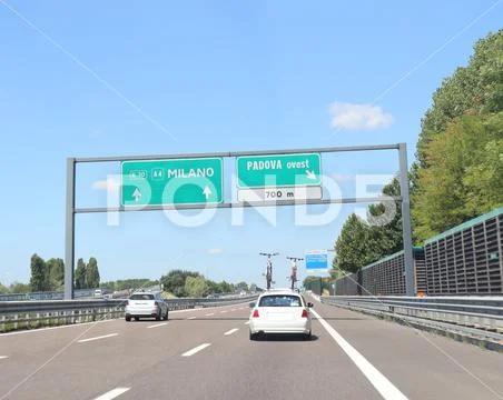 Photograph: Highway sign with the names of the Italian cities of Milan ...