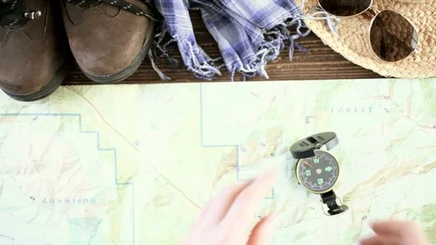 Hiking shoes with topo map and compass o... | Stock Video | Pond5