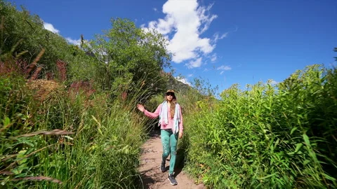 Hiking on trail following women female m... | Stock Video | Pond5