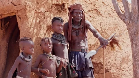Himba tribe father and kids near hut, Me... | Stock Video | Pond5