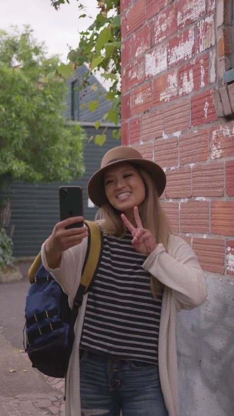 Hip Student Shows Peace Sign On Phone | Stock Video | Pond5