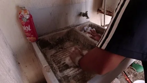 Hispanic Male Handwashing Clothes in a C... | Stock Video | Pond5