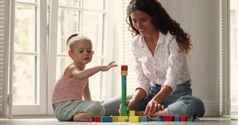 Hispanic nanny build block tower with li... | Stock Video | Pond5