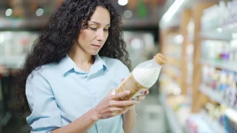 Hispanic woman chooses dairy products ho... | Stock Video | Pond5