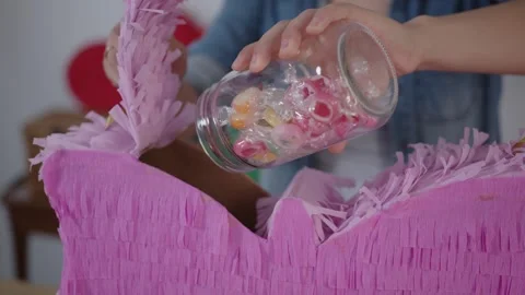 Hispanic woman filling Mexican pinata wi... | Stock Video | Pond5