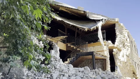A historic stone wall building is damage... | Stock Video | Pond5