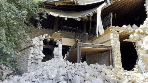 A historic stone wall building is damage... | Stock Video | Pond5