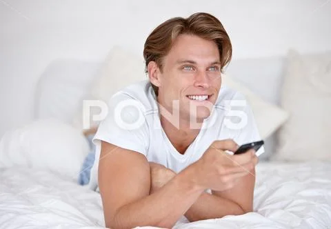 Hmm, I wonder whats on. A handsome young man wearing his pjamas and ...