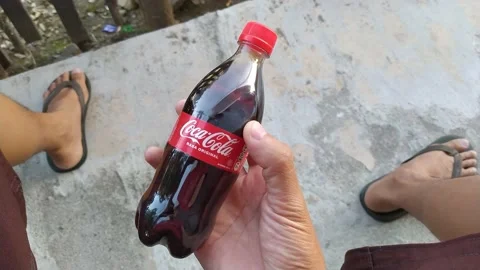 holding a Coca-Cola drink in a medium si... | Stock Video | Pond5