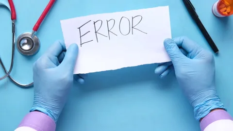 holding medical error text on a paper wi... | Stock Video | Pond5