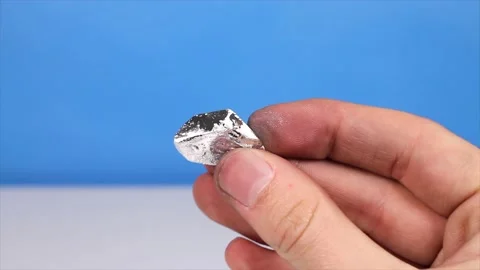 Holding solid Gallium (Ga) metal | Stock Video | Pond5
