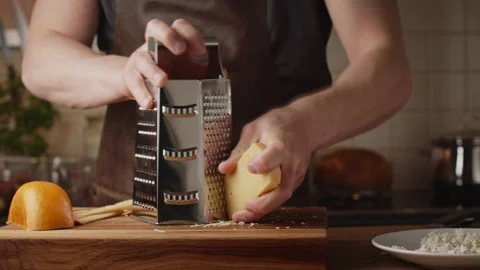Home Chef Grating Gouda Cheese | Stock Video | Pond5
