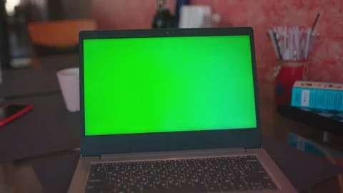 At home laptop computer with green scree... | Stock Video | Pond5
