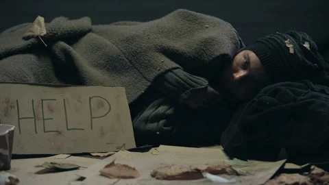 Homeless bum with help sign on board lyi... | Stock Video | Pond5