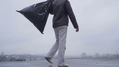 Homeless with garbage bag at the gloomy ... | Stock Video | Pond5